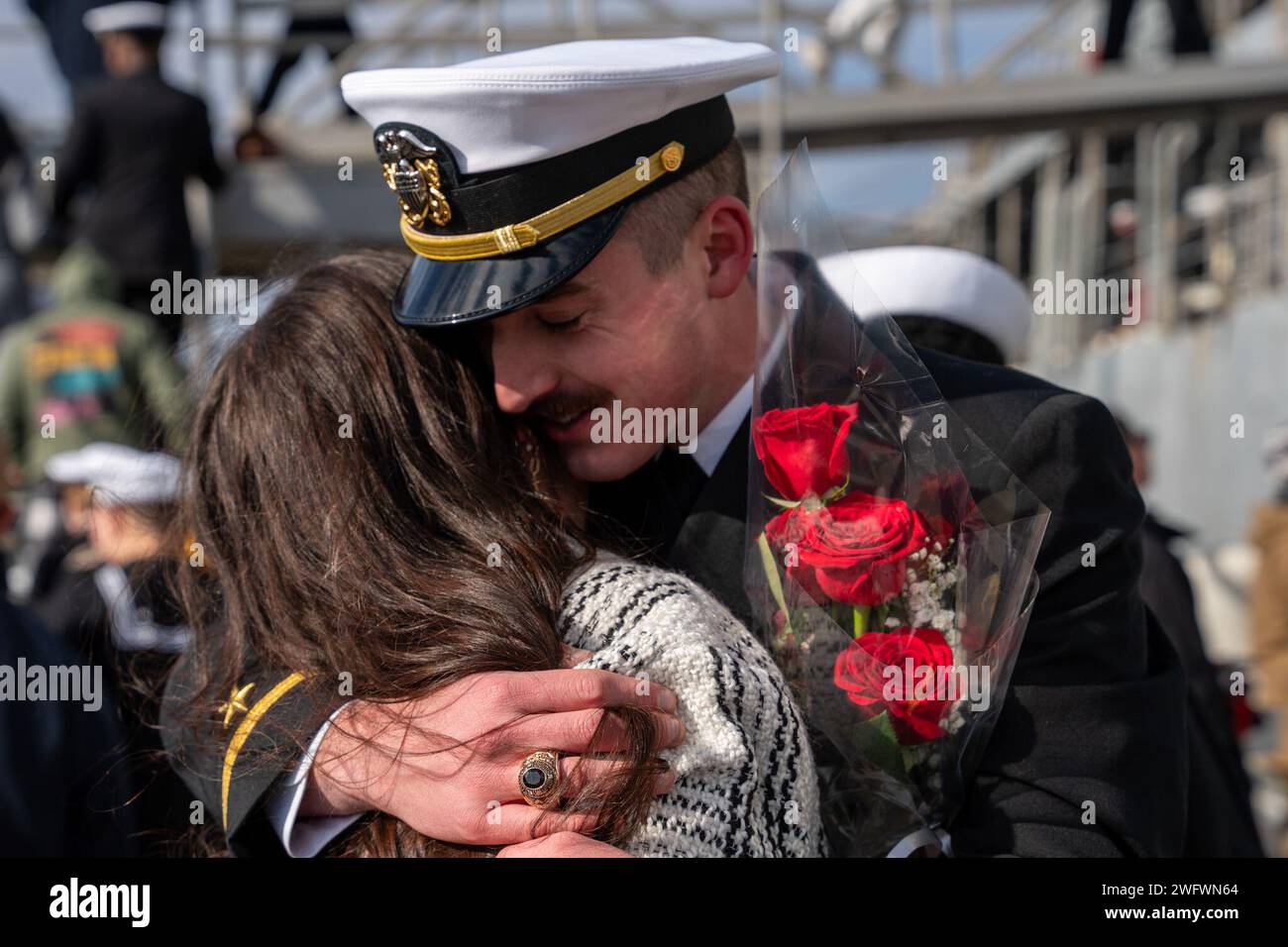 Ensign Dane Hamilton embraces his partner following the Ticonderoga ...