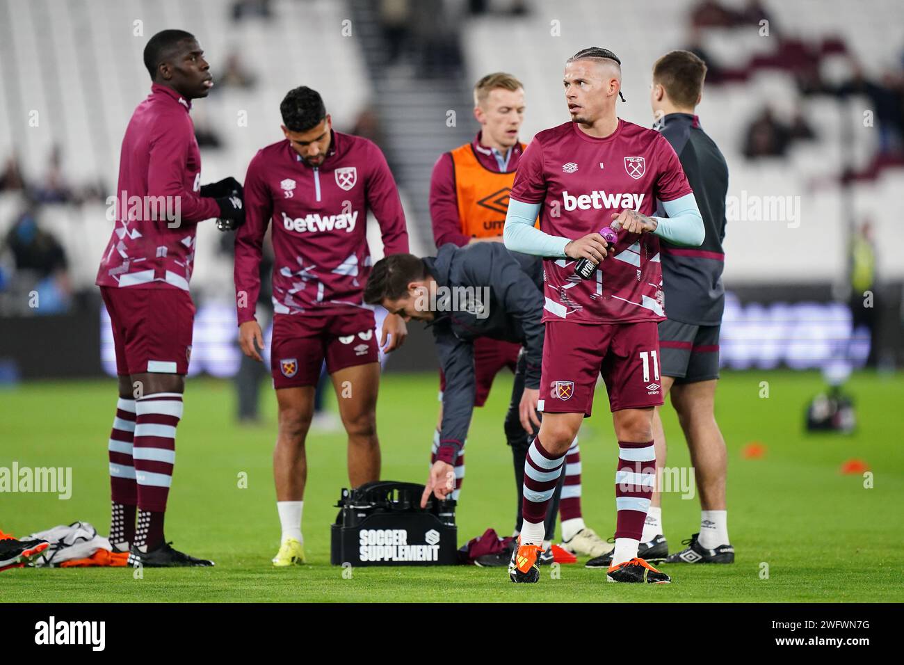 West Ham United's Kalvin Phillips (right) and team-mates warming up ...