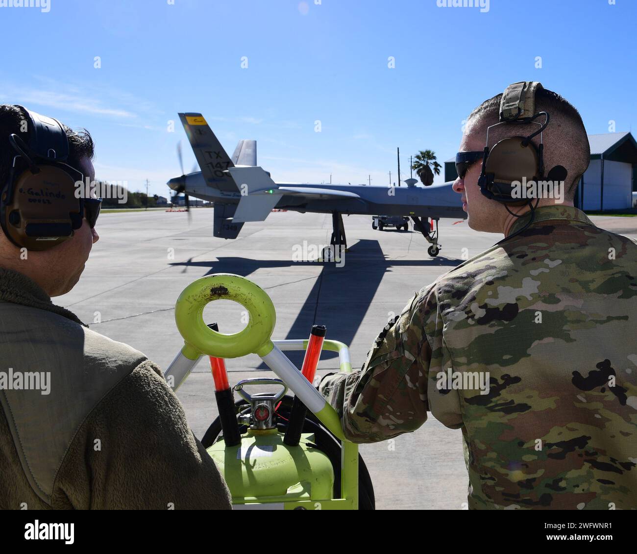 Members of the 147th Attack Wing Aircraft Maintenance Squadron watch as ...