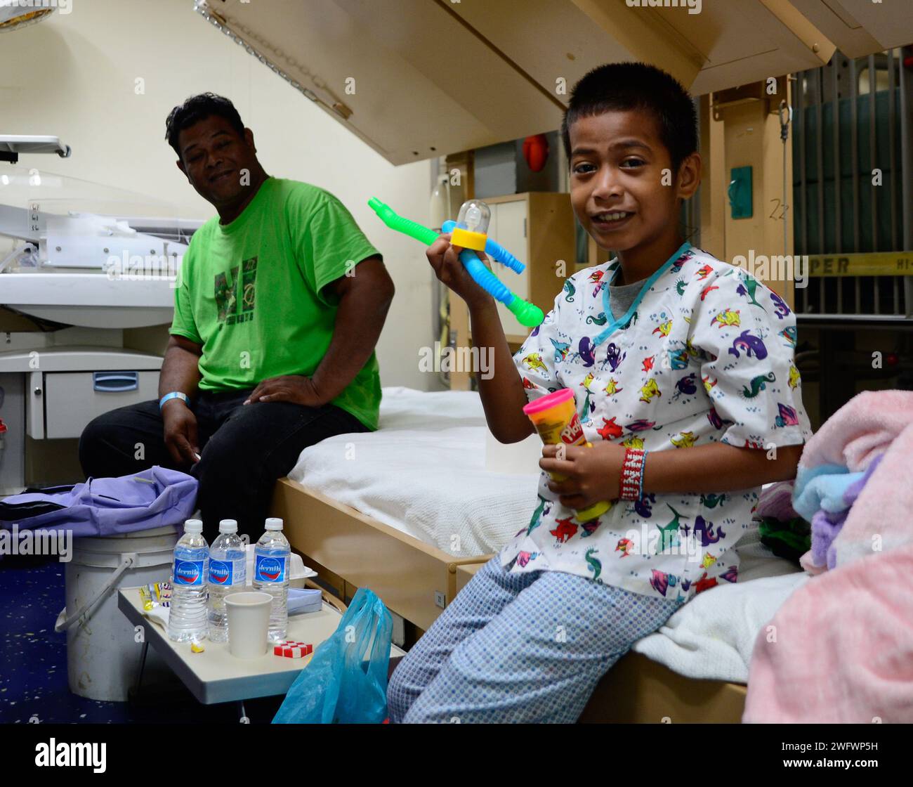 A pediatric patient shows off his toys in a patient ward aboard the ...