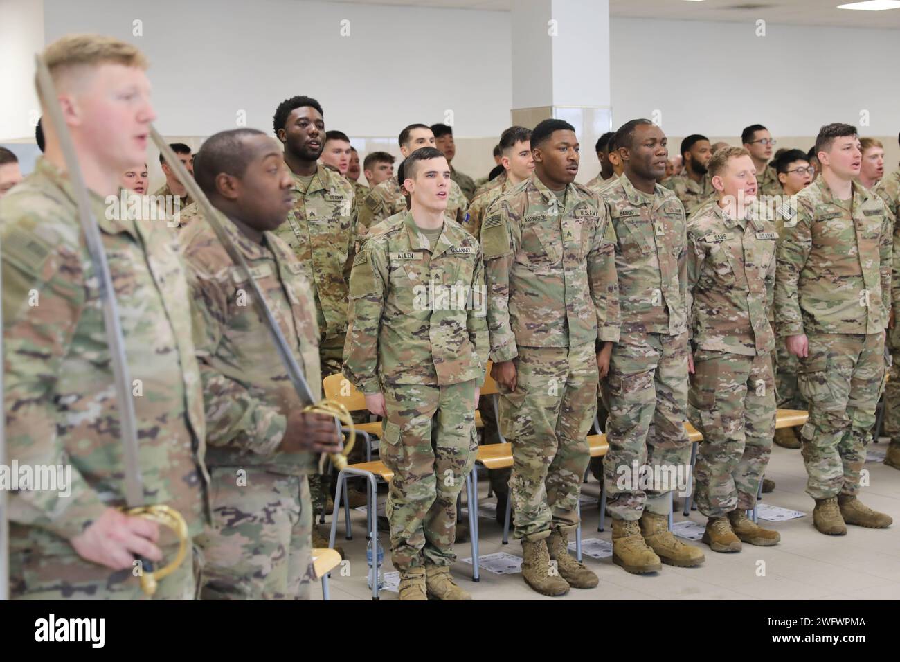 Newly promoted U.S. Army Noncommissioned Officers stand at attention as ...