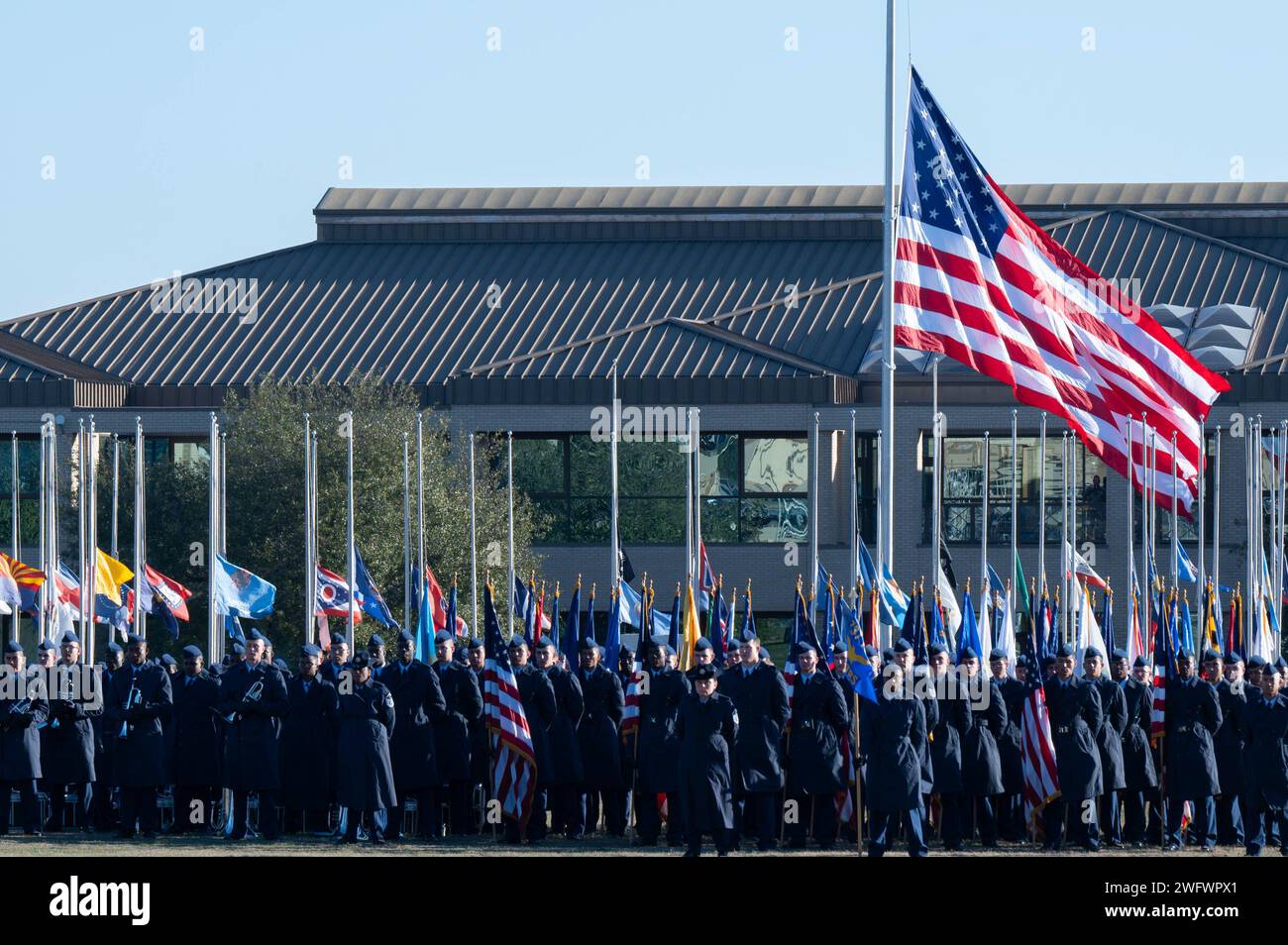 Air Force basic military trainees stand at parade rest before the ...