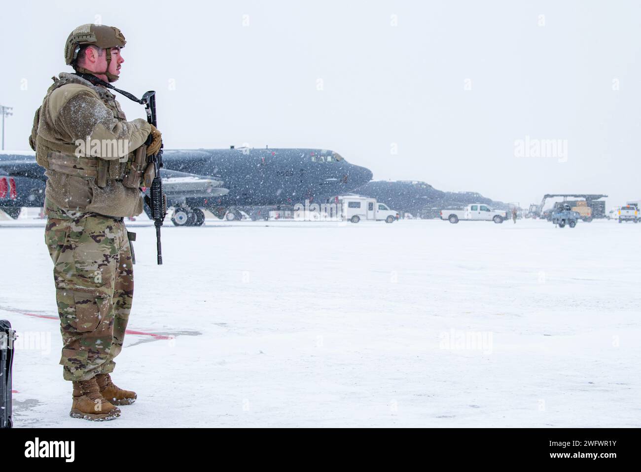 A defender from the 5th Bomb Wing Security Forces Squadron stands guard ...