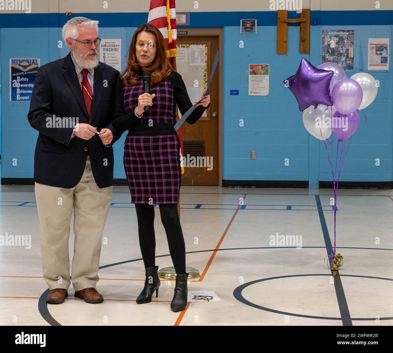 The Purple Star Award is presented to Dr. Stephen Young, Memorial middle school principal, at ...