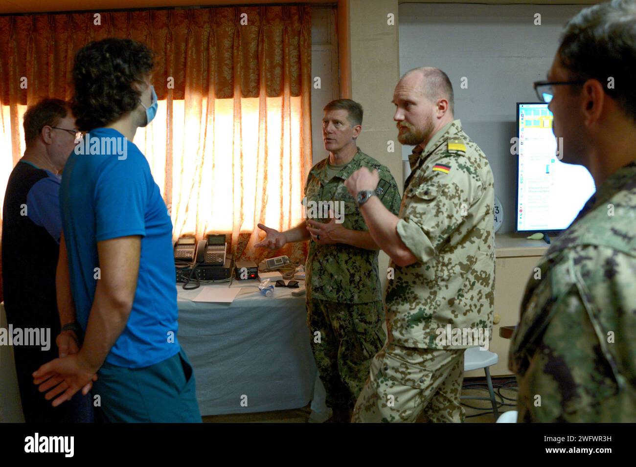 U.S. Navy Capt. Daniel Switlick, middle, talks to local Micronesian ...