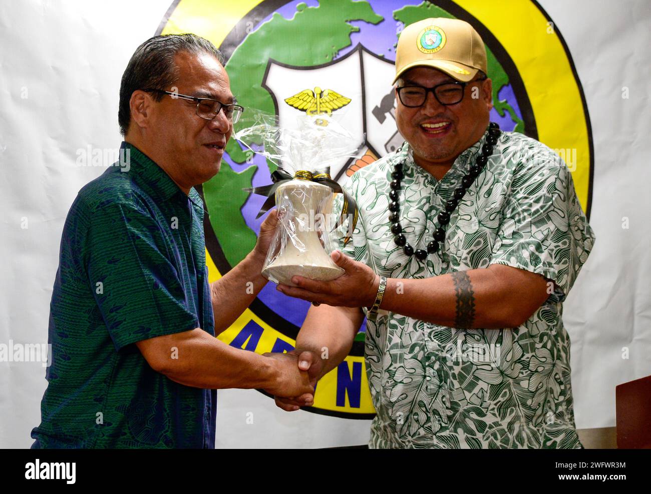 Alexander Narruhn, governor of the state of Chuuk, right, presents ...