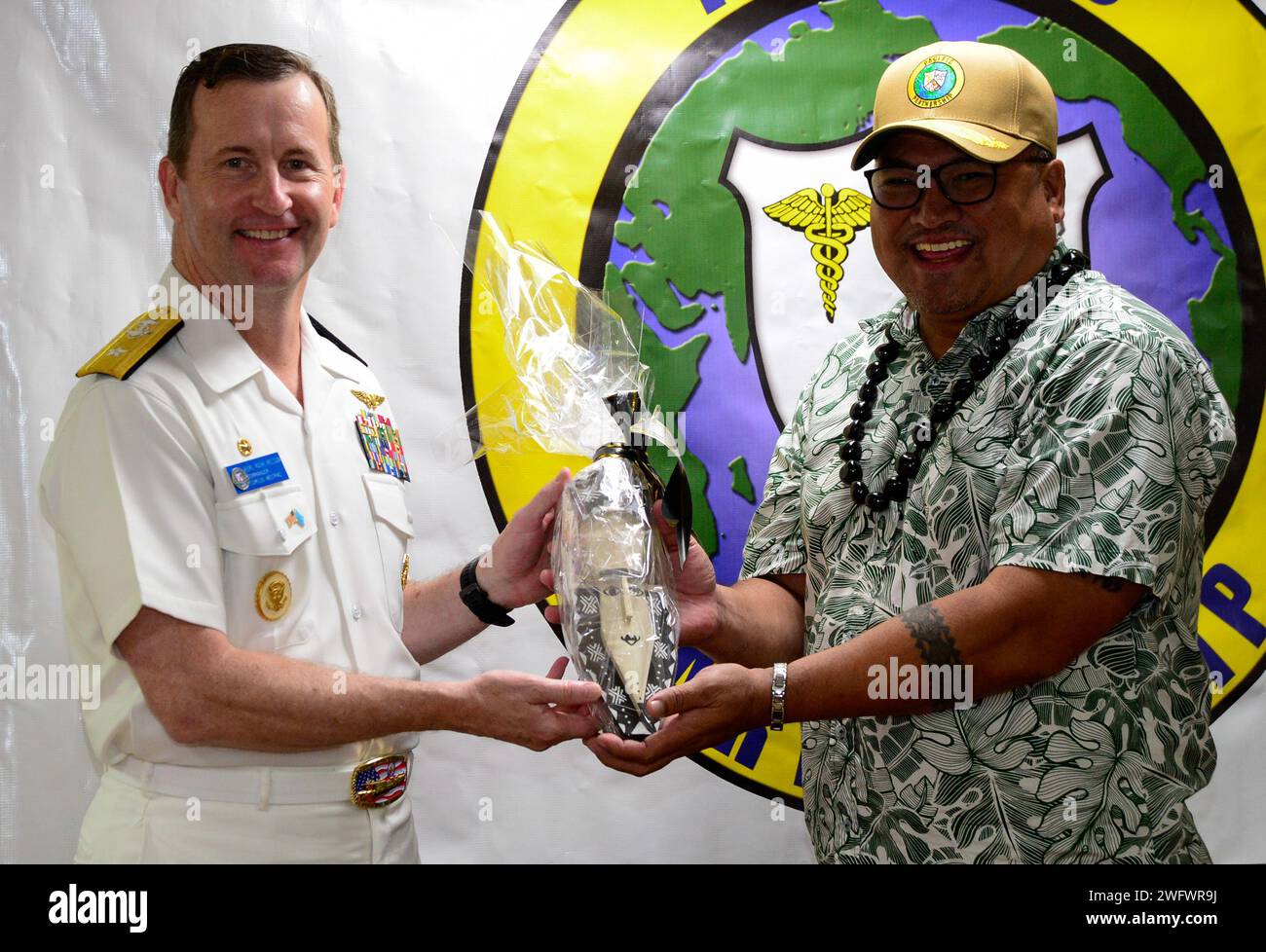 Alexander Narruhn, governor of the state of Chuuk, right, presents U.S ...