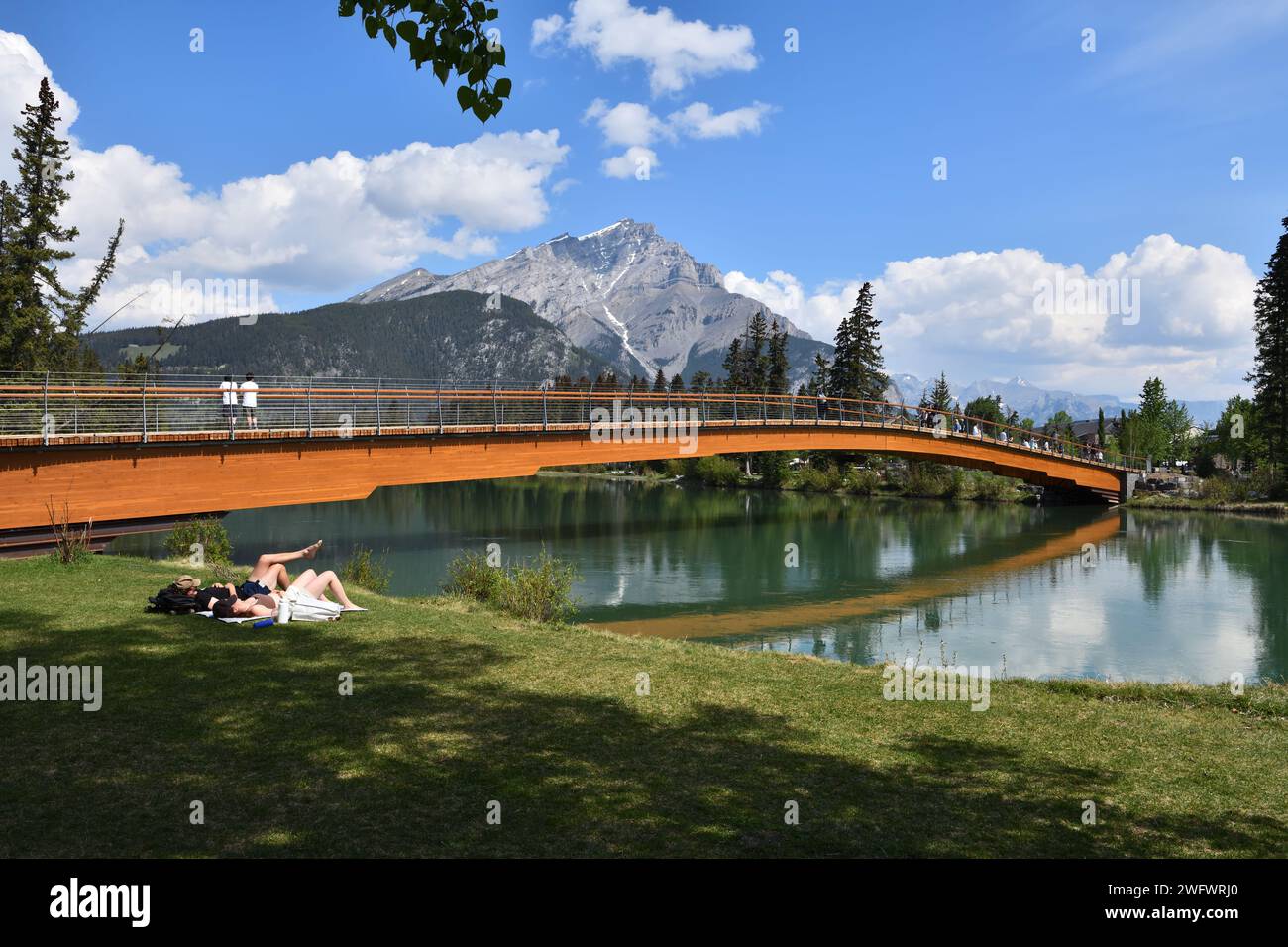 Banff pedestrian bridge crossing the Bow River with Cascade Mountain in ...