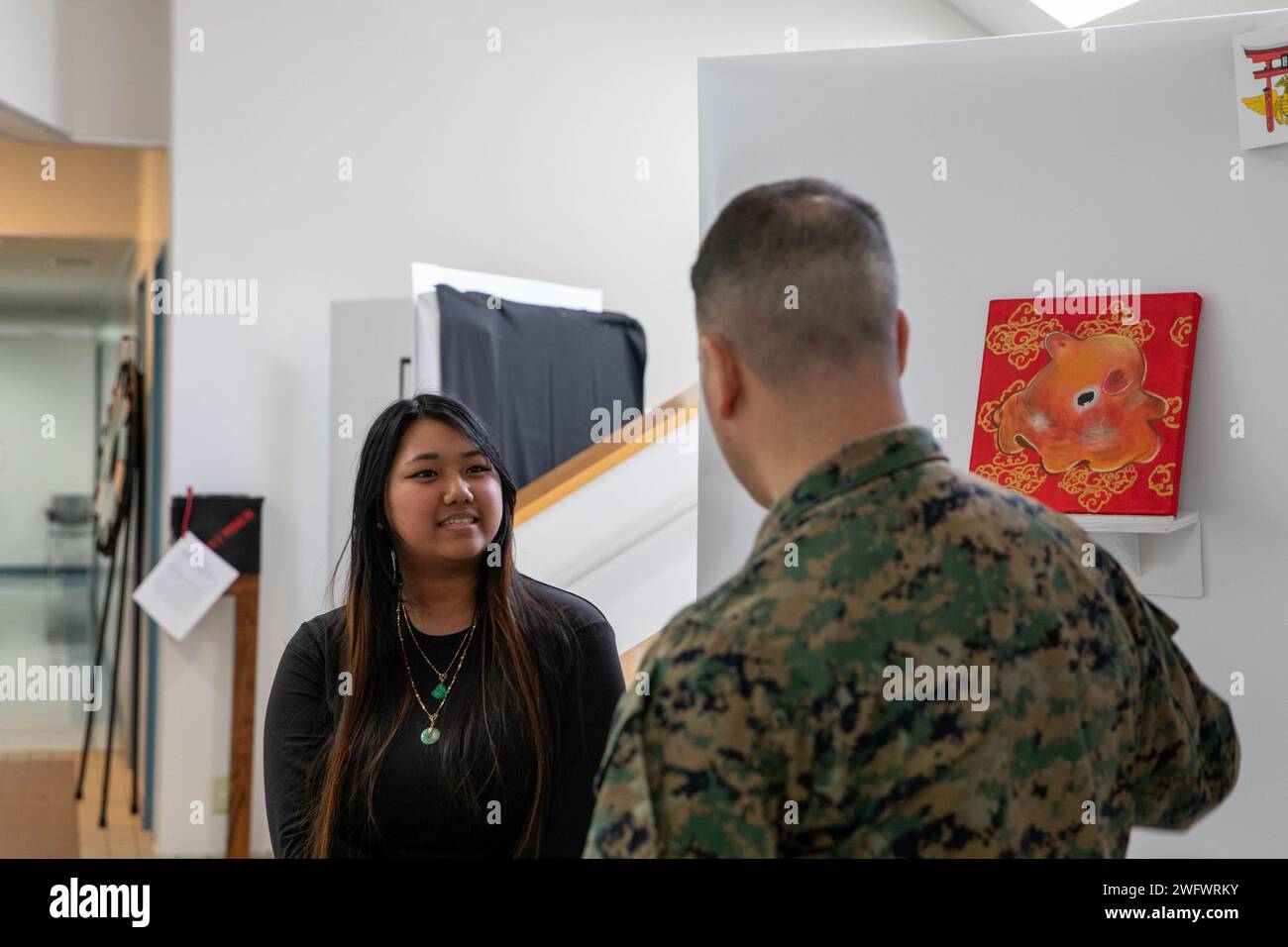 A student from Matthew C. Perry High School, left, describes her ...