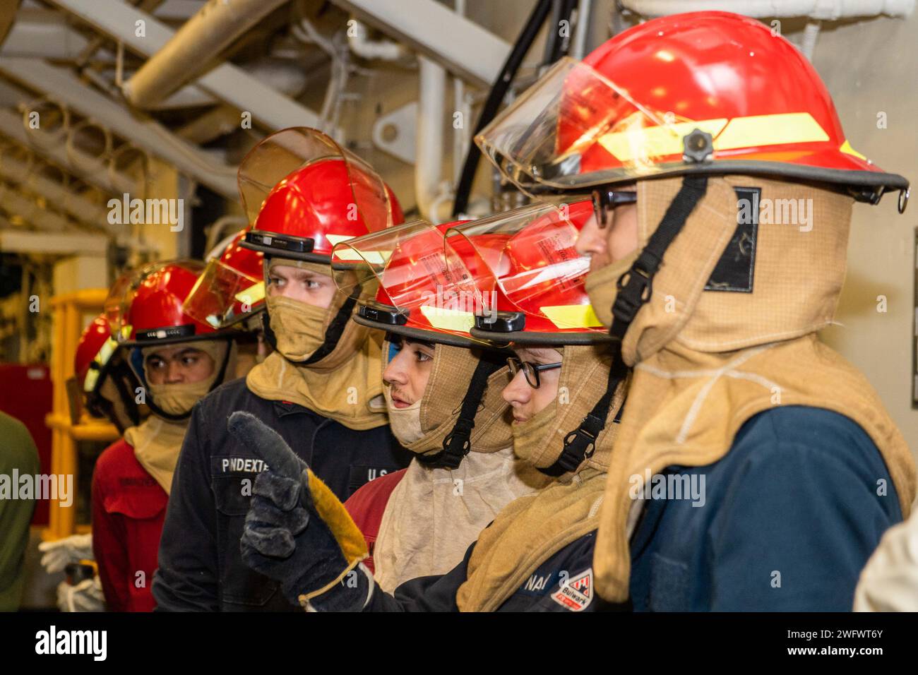Sailors assigned to USS Boxer (LHD 4) await instruction during a damage ...