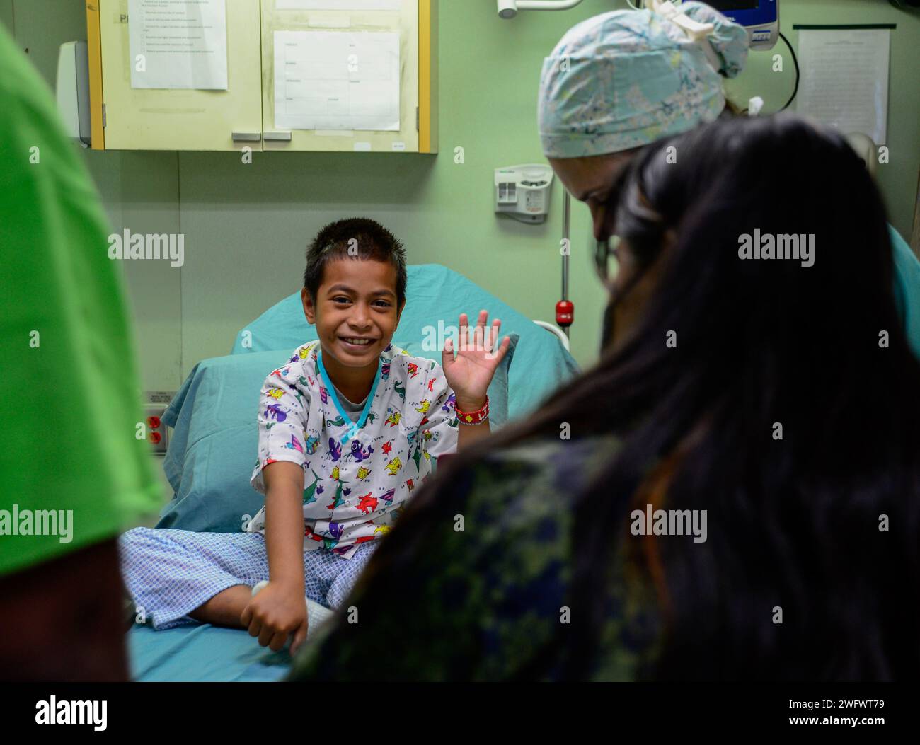 A Chuukese pediatric patient poses for a photo during a pre-operative ...