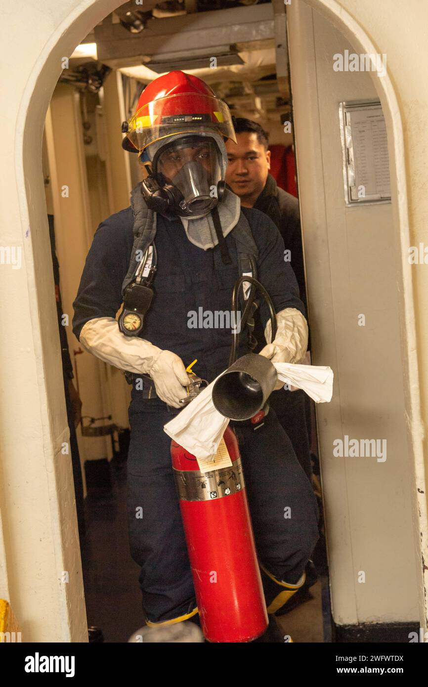 Yeoman 1st Class Altemus Butler, a native of Anchorage, Alaska, carries ...