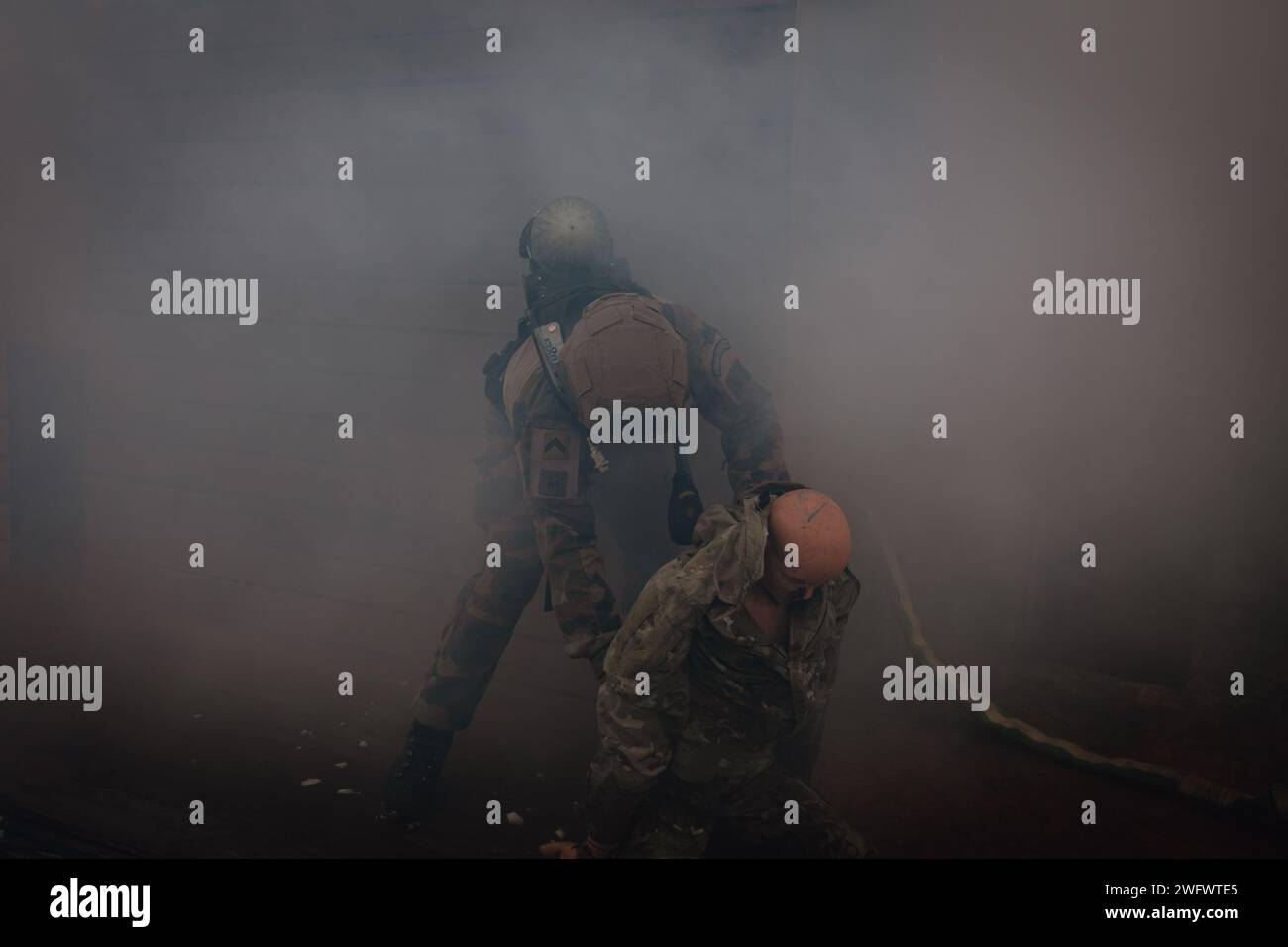 French Armed Forces firefighter Sgt. Lorenzo Thomas carries a mannequin ...
