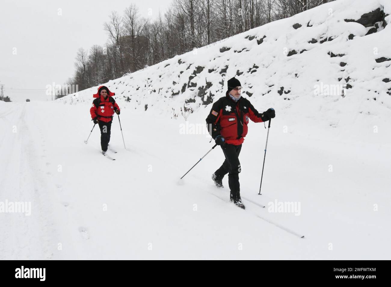 National Ski Patrol members make their way to the rappelling site where ...