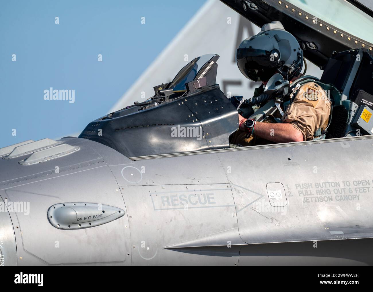 A U.S. Air Force fighter pilot performs flight pre-checks during ...