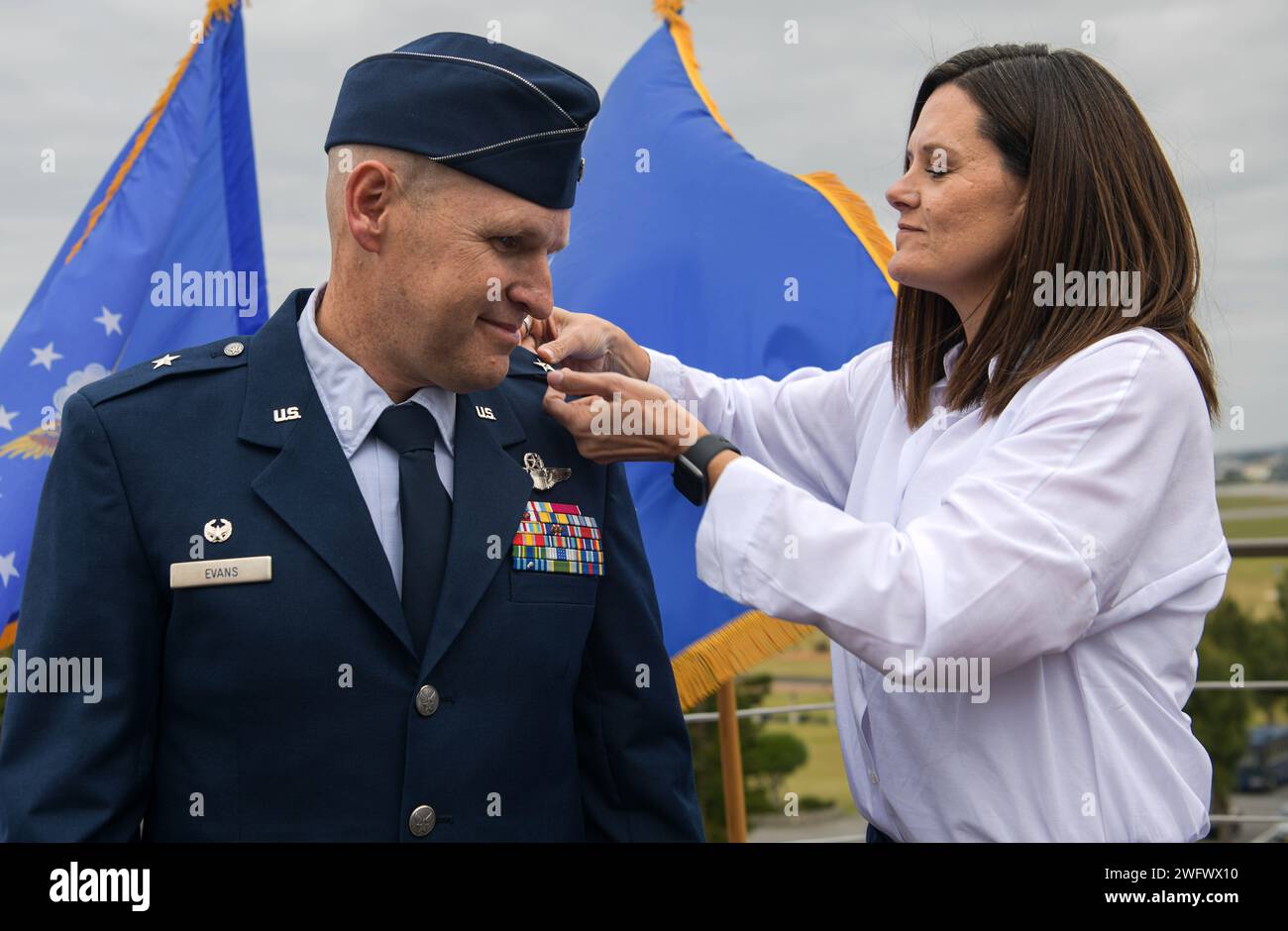 Shelley Evans, right, pins on the rank of her husband, U.S. Air Force Brig. Gen. Nicholas Evans ...