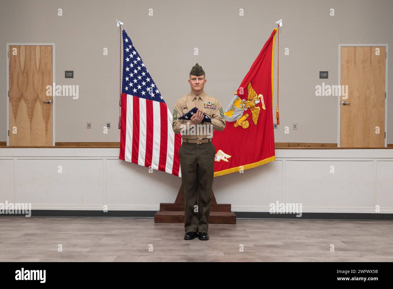U.S. Marine Corps 1st Sgt. Neill A. Sevelius holds an American flag ...
