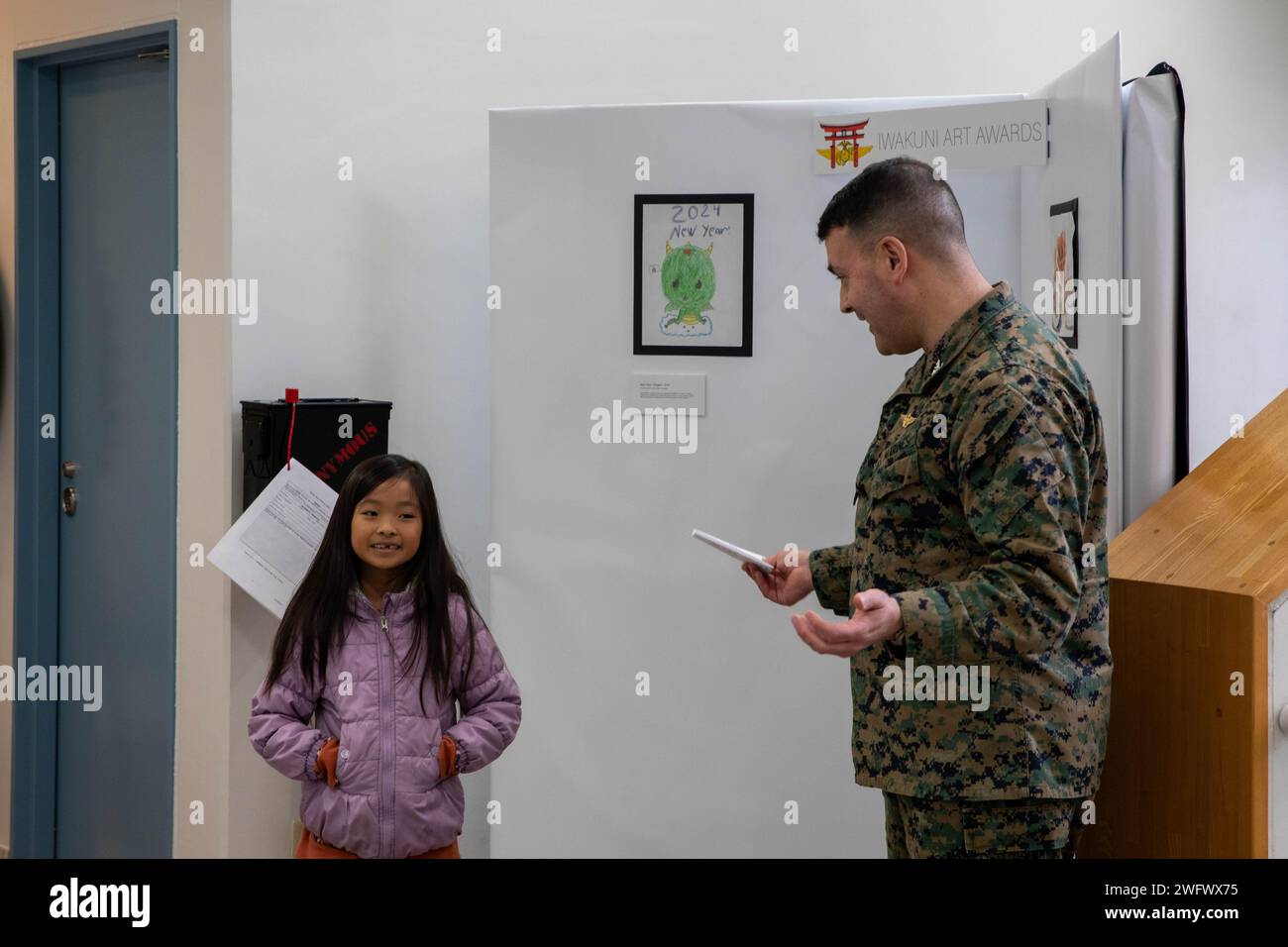 A student from Matthew C. Perry Elementary School, left, describes her ...