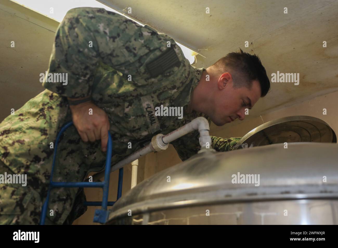 U.S. Navy Lt. Nickolas Lamal, from Green Bay, Wisconsin, checks the ...