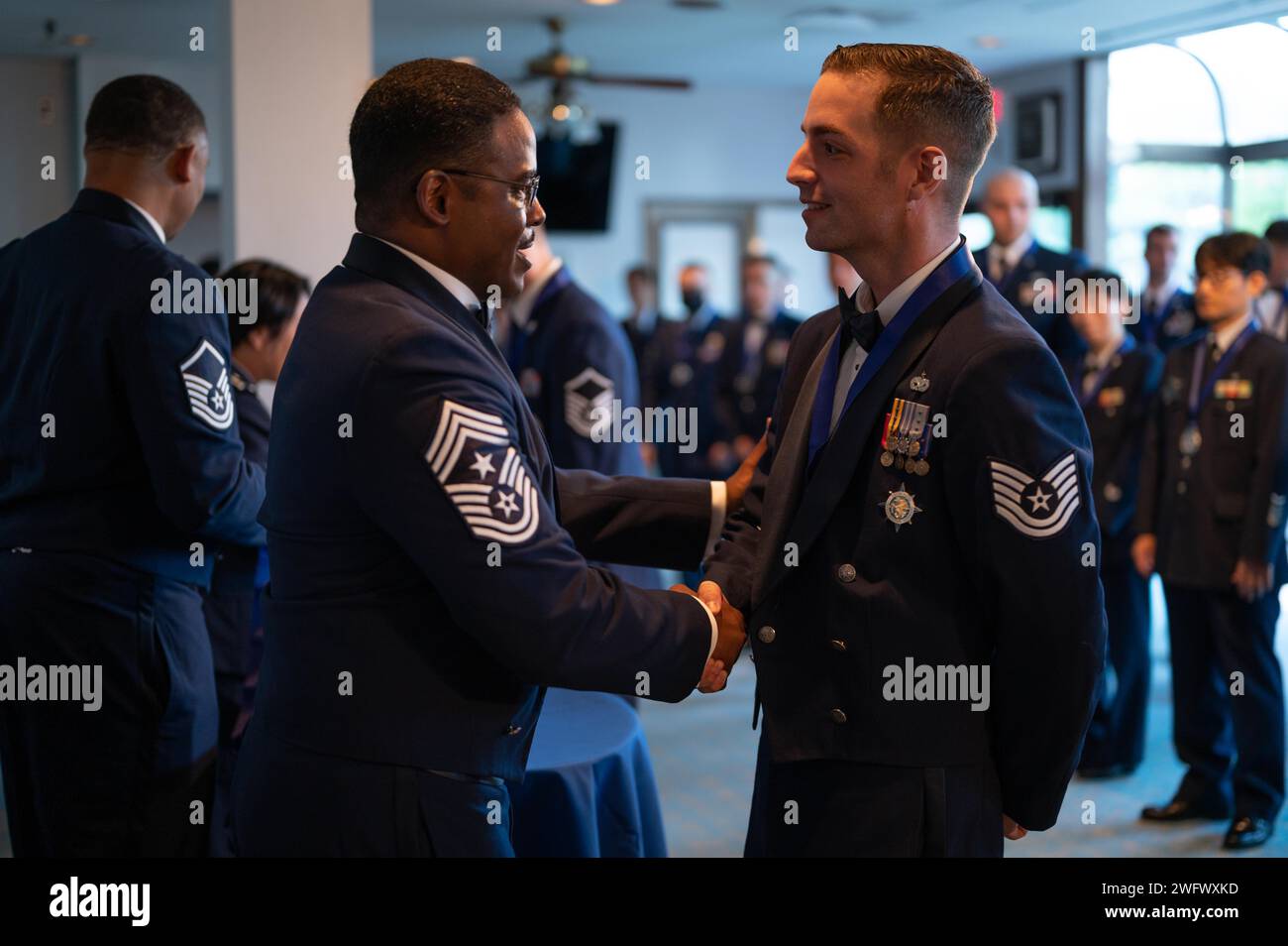 Chief Master Sgt. Jerry Dunn, 374th Airlift Wing command chief, left ...