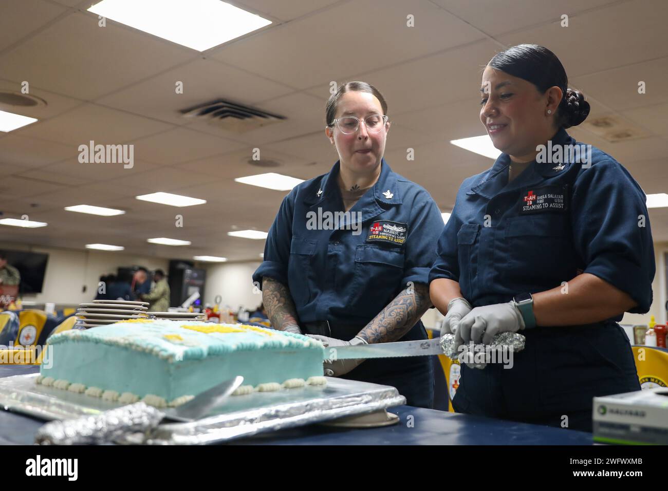 U.S. Navy Sailors prepare to cut a cake at the conclusion of a Martin ...