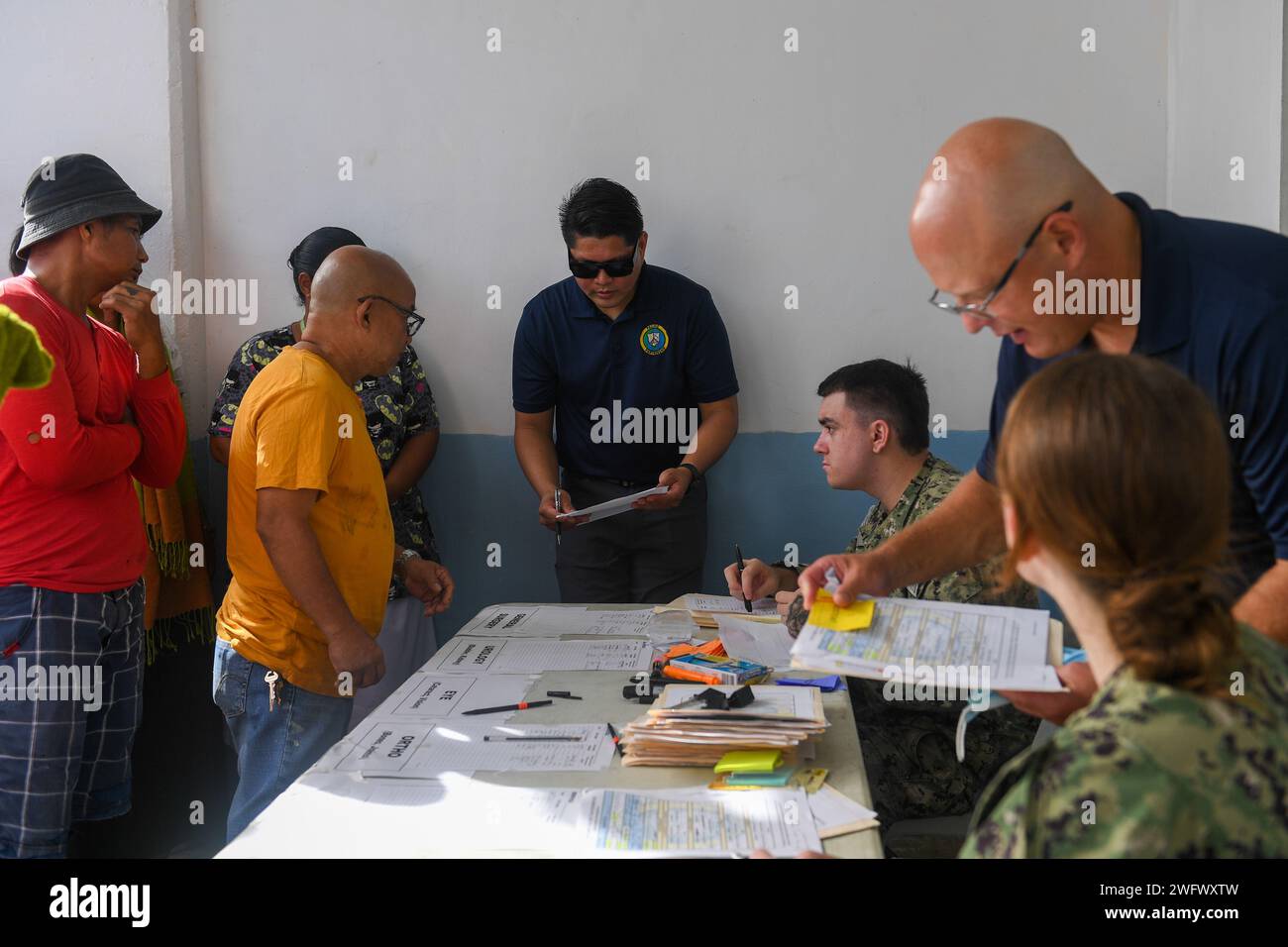 U.S. Navy Sailors review documents for pre-op screening at Chuuk State ...
