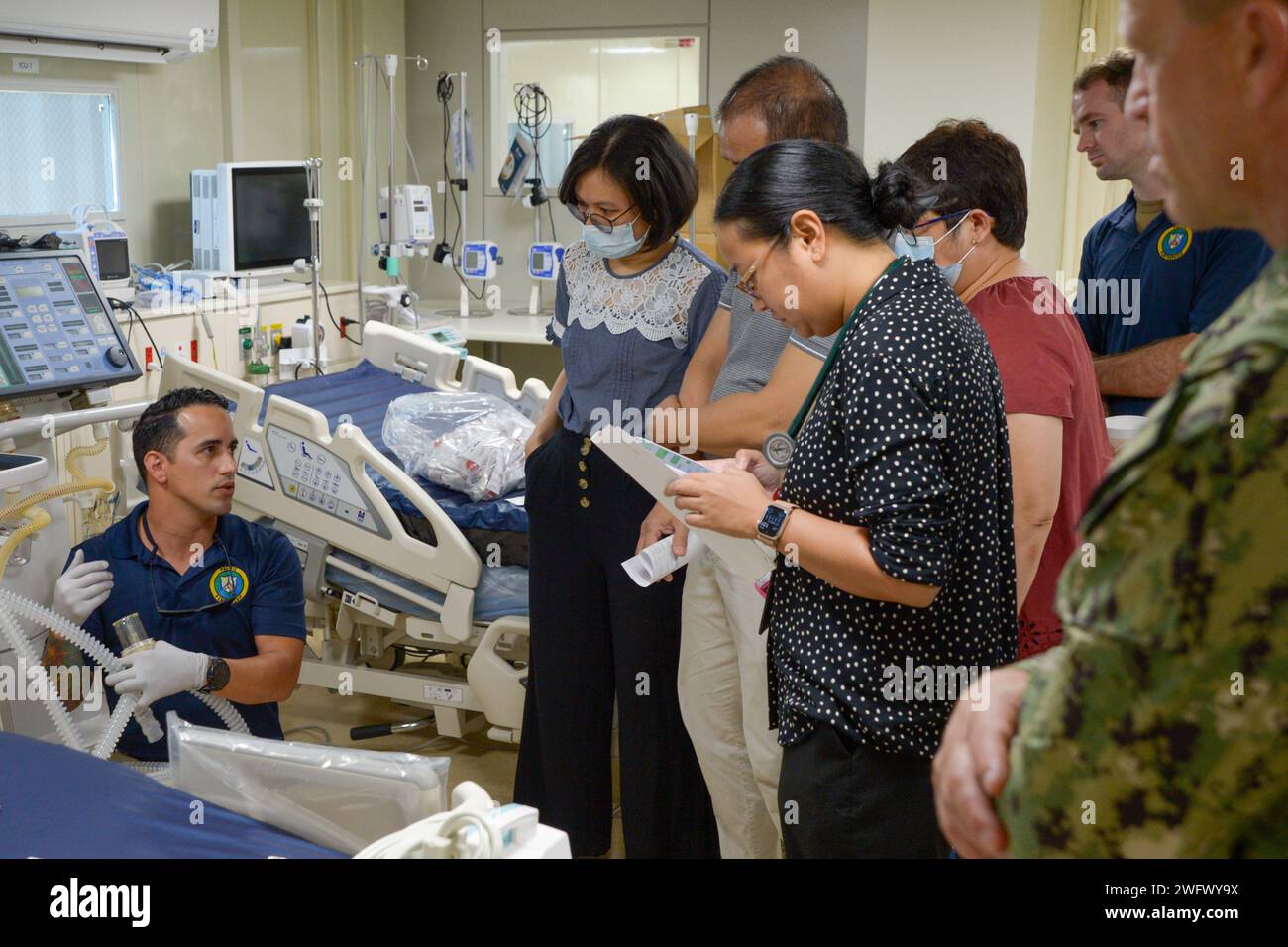 U.S. Navy Chief Hospital Corpsman Christian Miranda, left, present ...