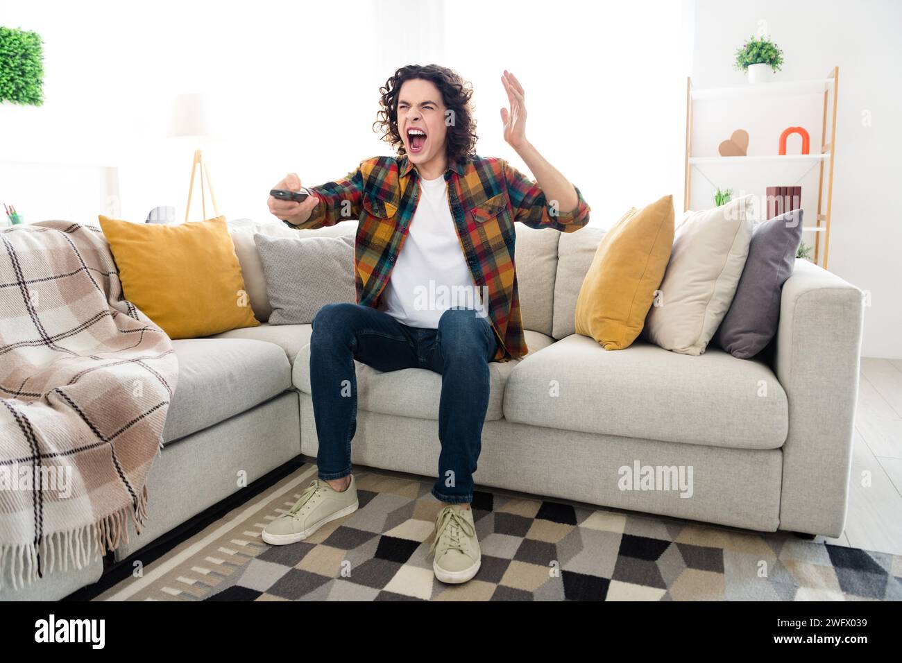Teenager watching tv angry hi-res stock photography and images - Alamy