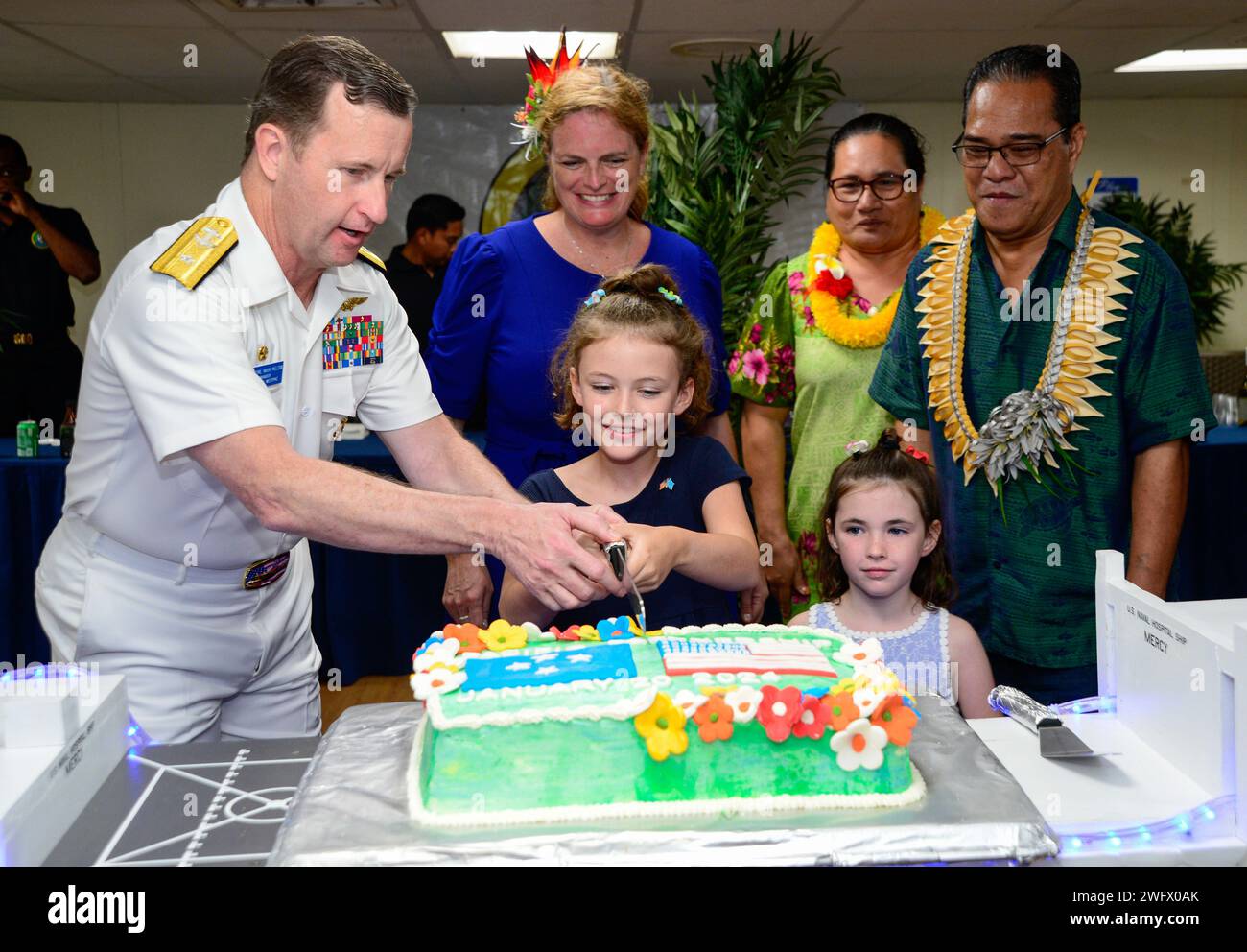U.S. Navy Rear Adm. Mark Melson, commander of Task Force 73, left ...