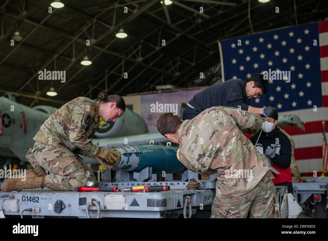 Members from the 51st Munitions Squadron prepare munitions to be loaded ...