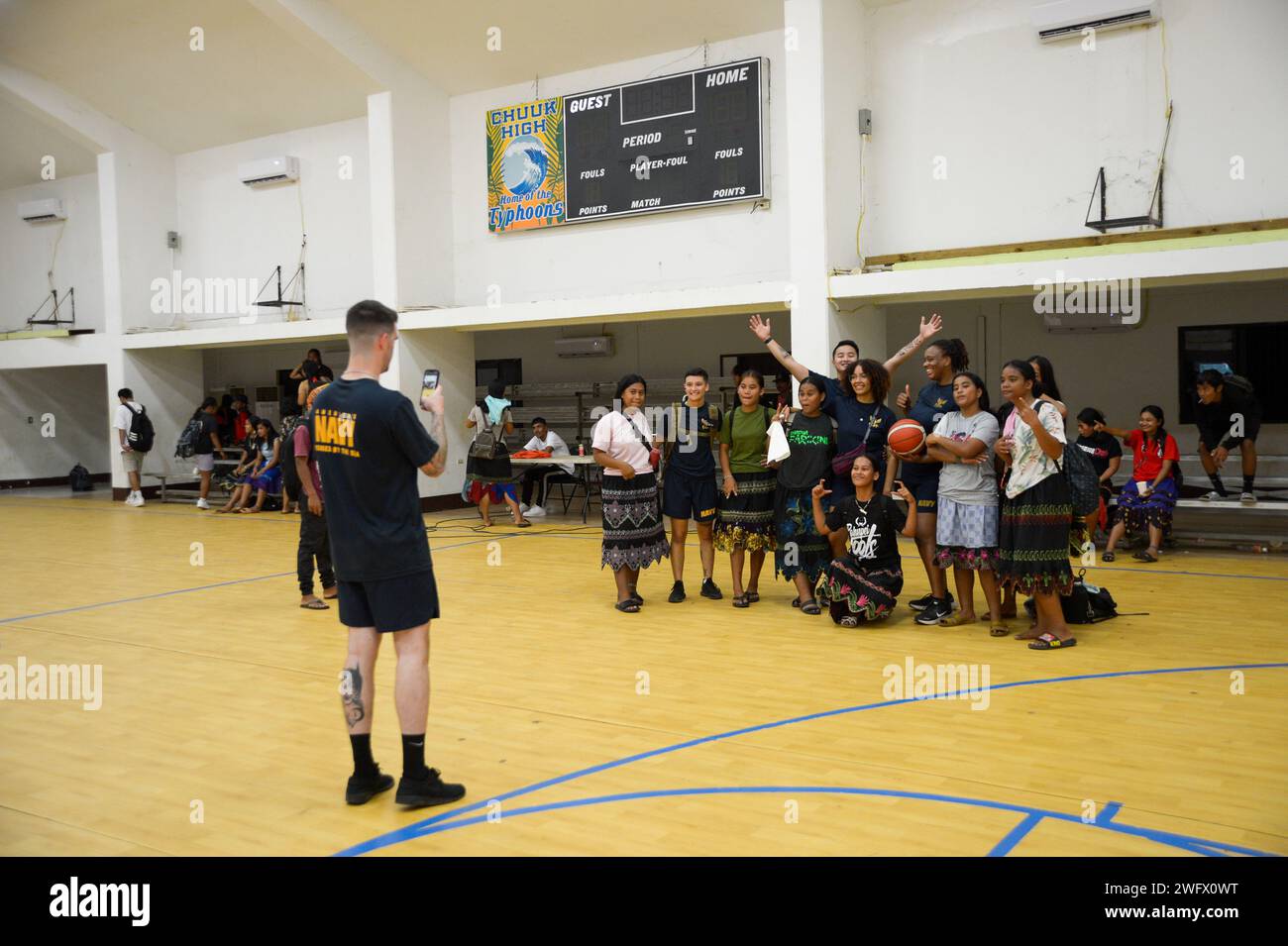 U.S. Navy Sailors pose for a photo with local Micronesian school ...