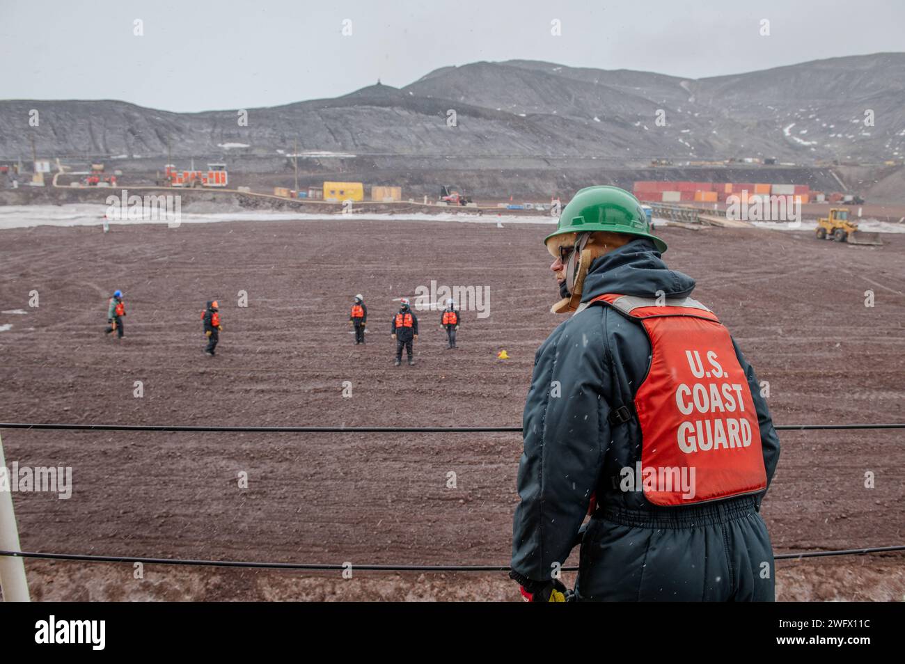 U.S. Coast Guard Seaman Chase Schlueter awaits a command from the deck ...