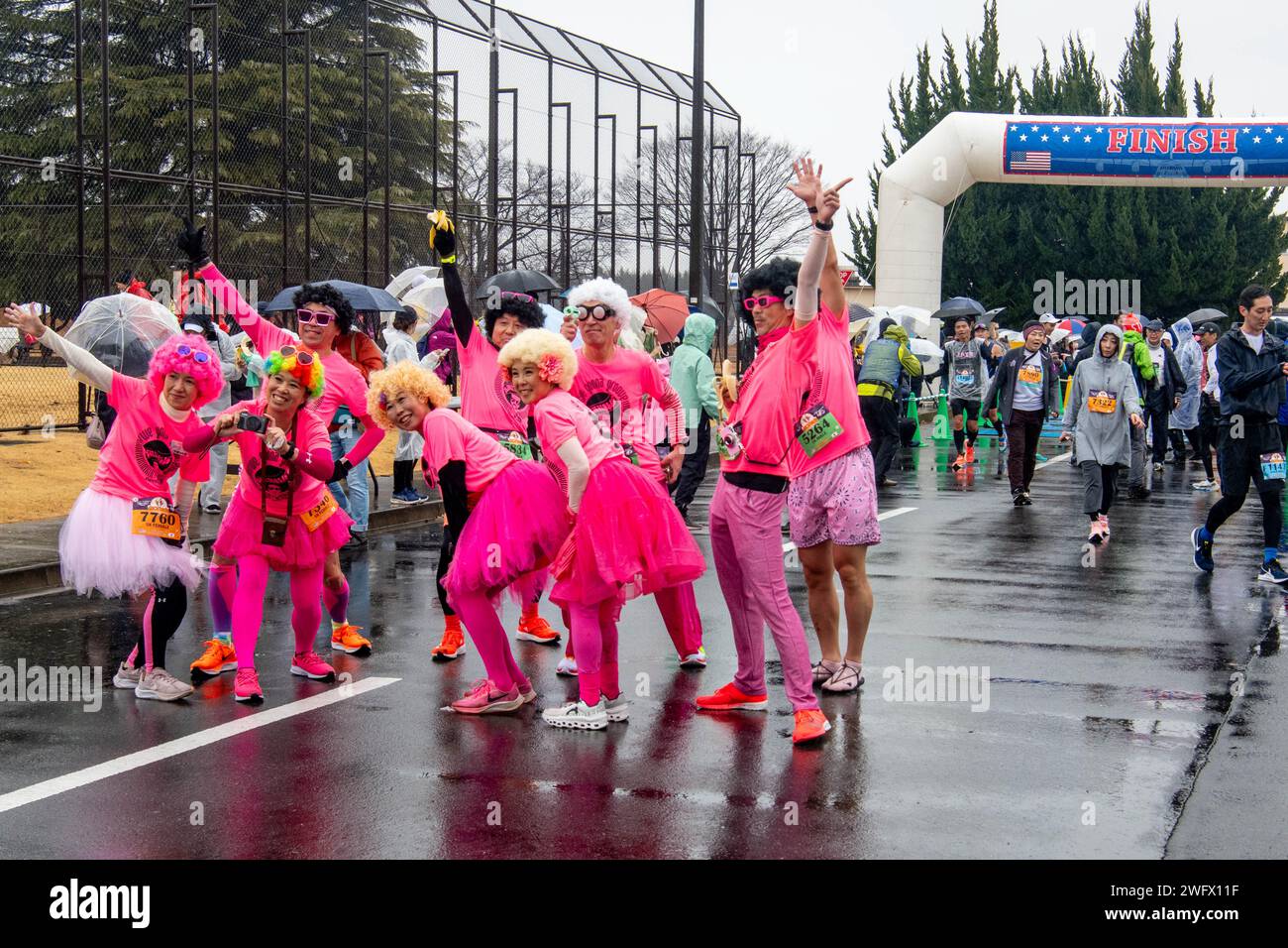 Runners participating in the 5K road race pose for a photo after ...