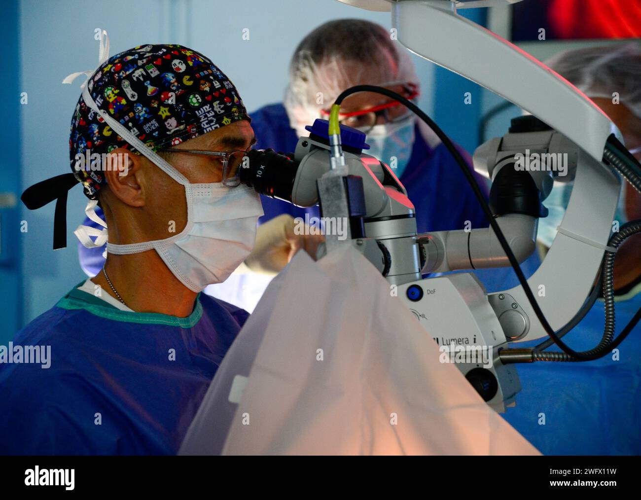 U.S. Navy Cmdr. Gabe Valerio, from San Diego, performs a pterygium ...