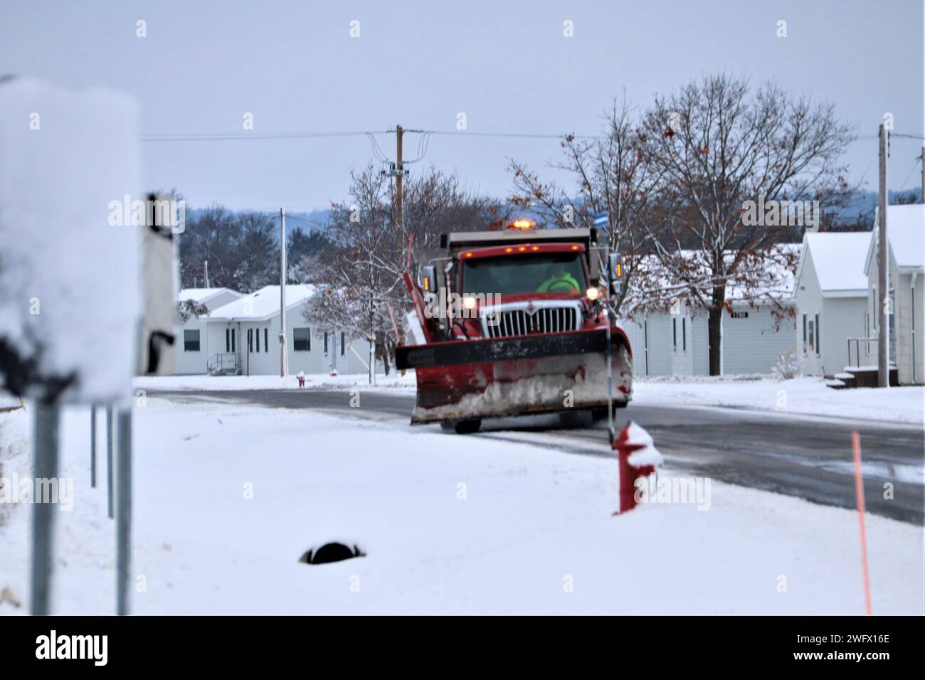 An equipment operator with the Fort McCoy snow-removal team clears snow ...
