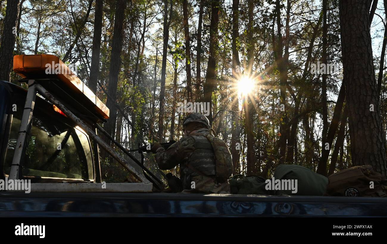 A U.S. Airman assigned to the 4th Civil Engineer Squadron aim an M4 ...