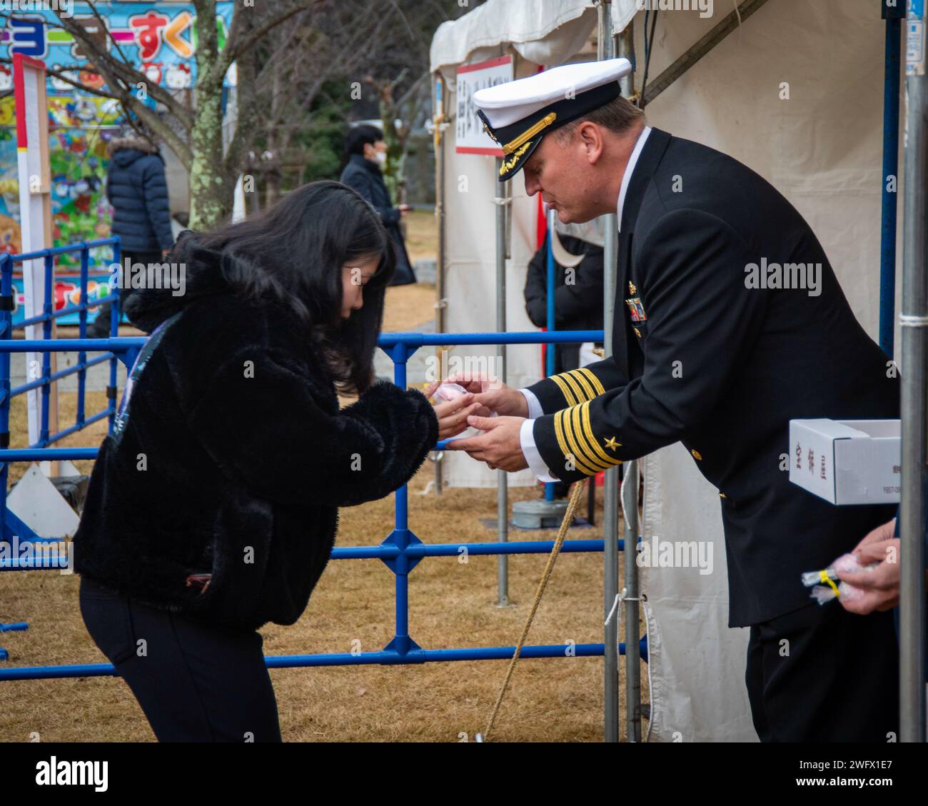 Capt. Michael Fontaine, Commander, Fleet Activities Sasebo, hands out ...