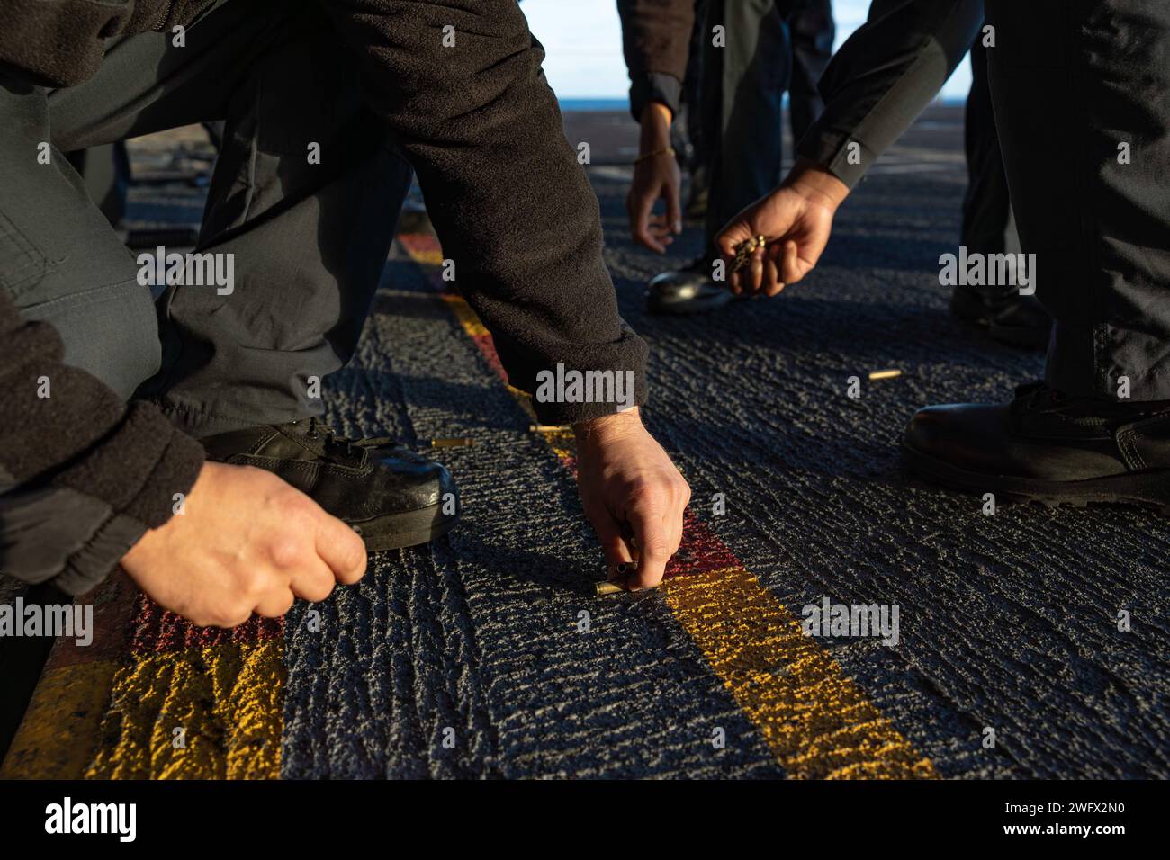 240126-N-LM220-1454 PACIFIC OCEAN (Jan. 26, 2024) Sailors pick up shell ...