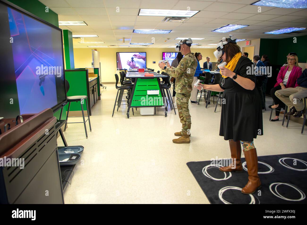 Post Command Sgt. Maj. David P. Hanson (left) and Tiffany Koch, Fort Johnson’s school liaison ...