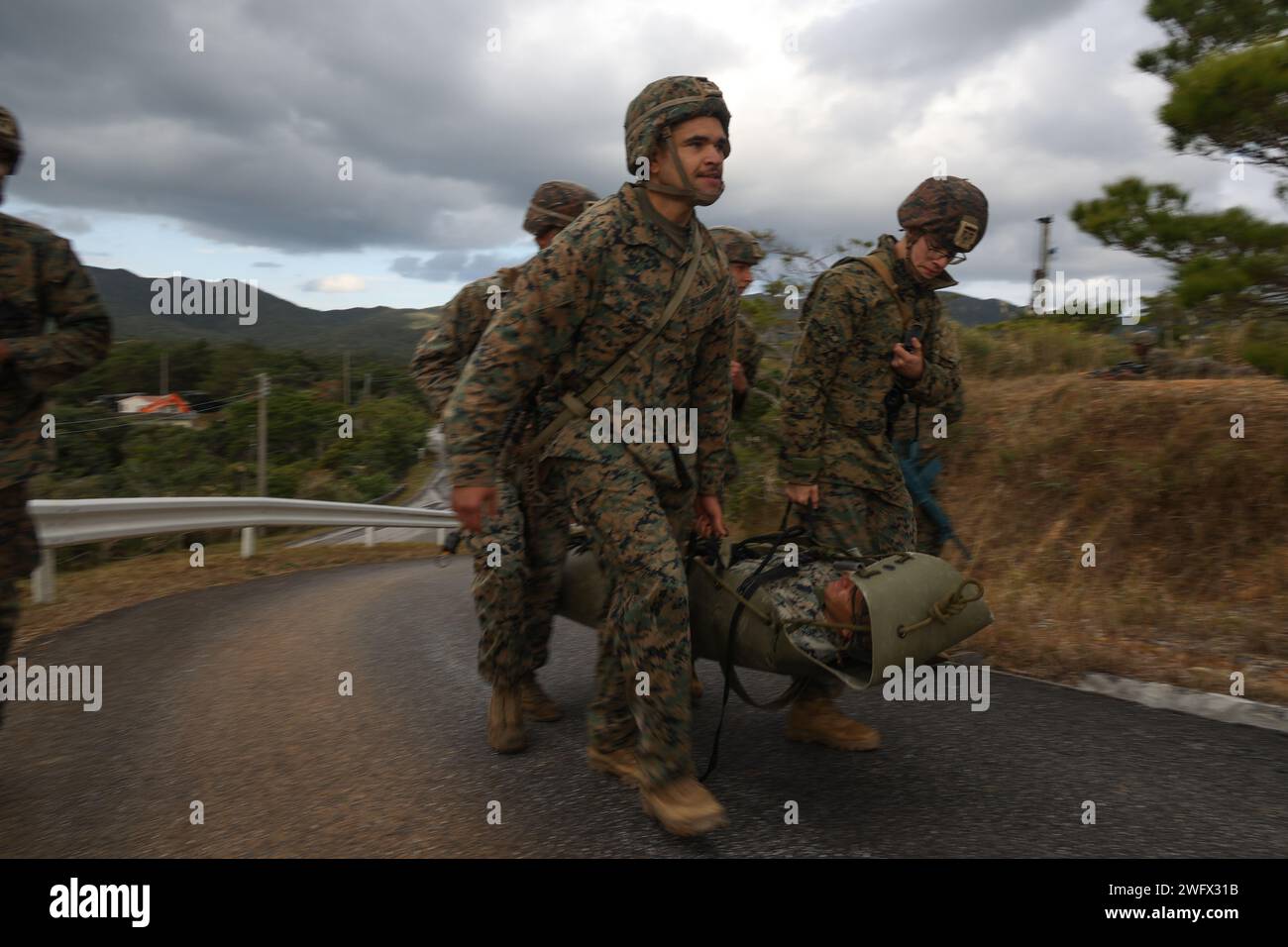 U.S. Marines with III Marine Expeditionary Force carry a simulated ...