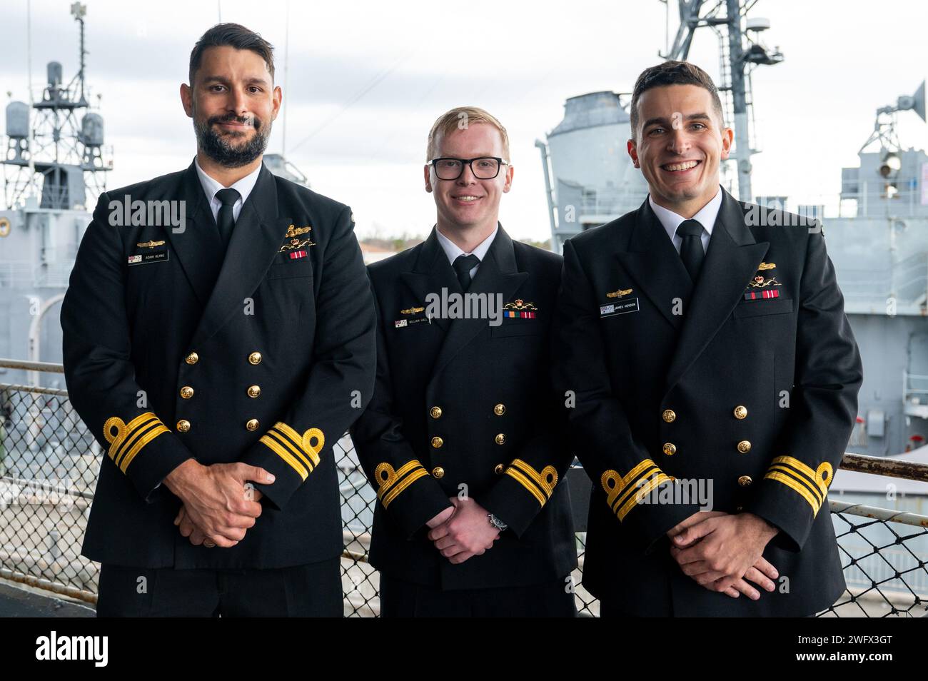 Royal Australian Navy Lt. Cmdr. Adam Klyne (left), Lt. William Hall ...