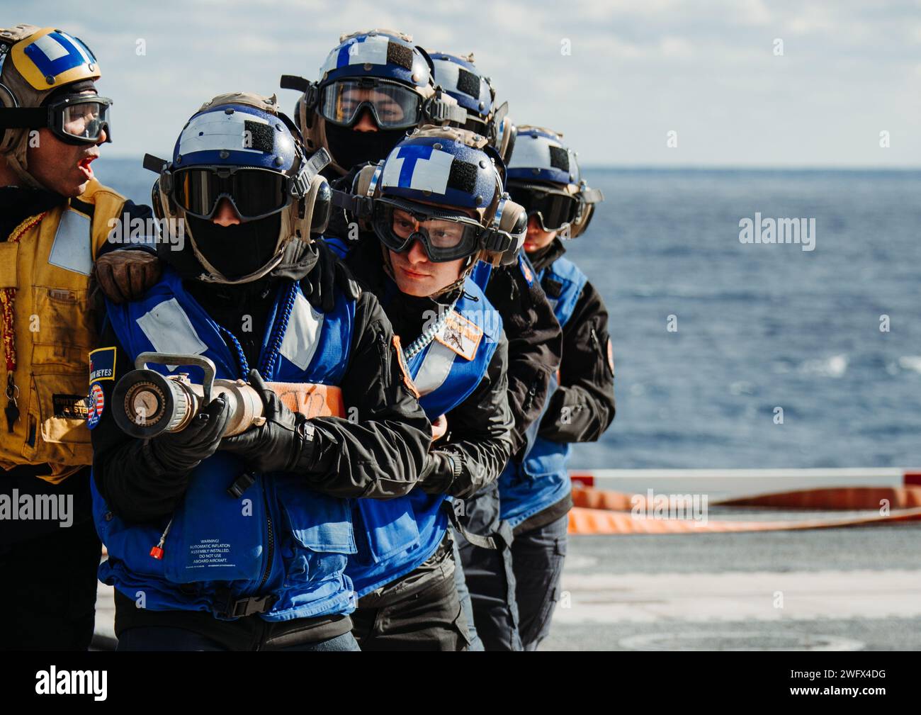 Sailors simulate fighting a fire during a mass casualty drill on the ...