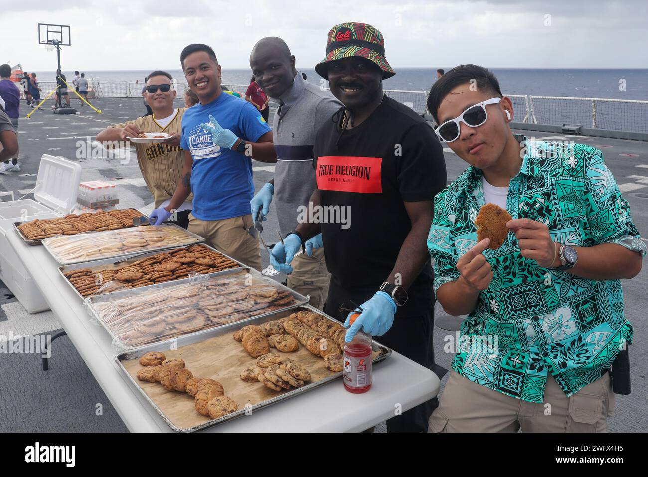 U.S. Navy Sailors serve cookies during a steel beach picnic aboard the ...