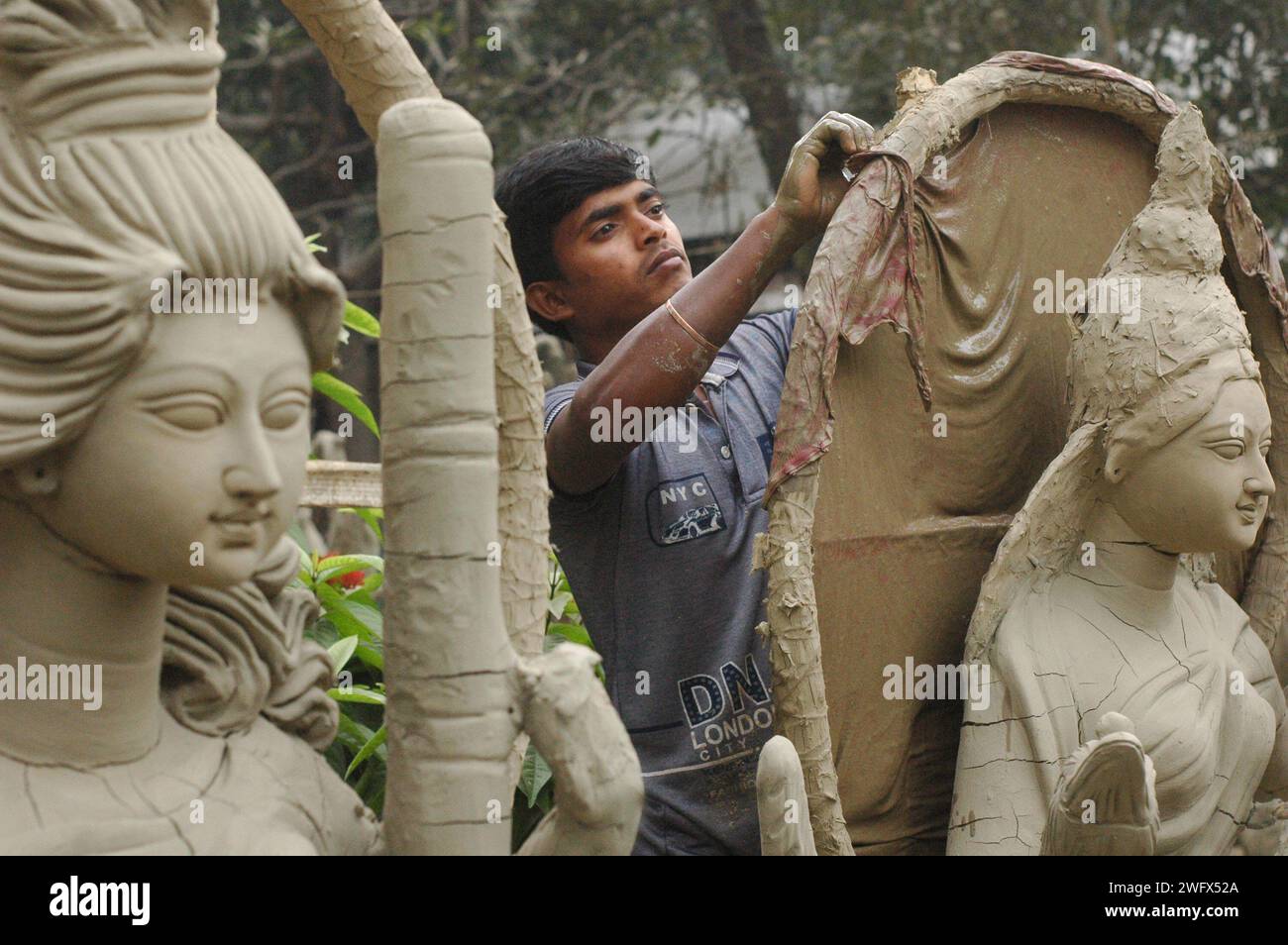 Dhaka, Bangladesh. 2nd Feb, 2024. A craftsman works on the clay idol of the goddess Saraswati ...