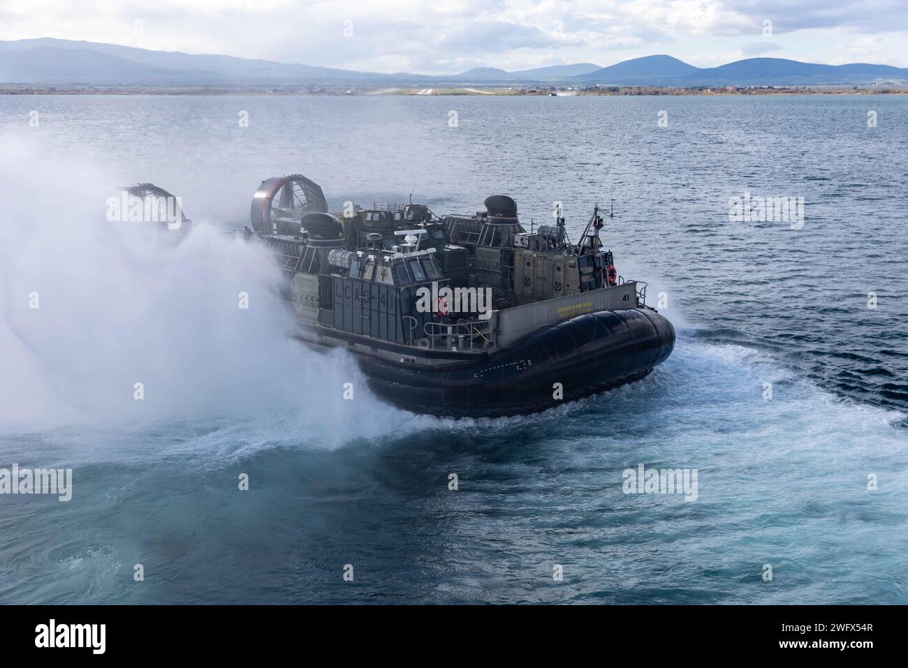 A U.S. Navy landing craft, air cushion, (LCAC) assigned to assault ...