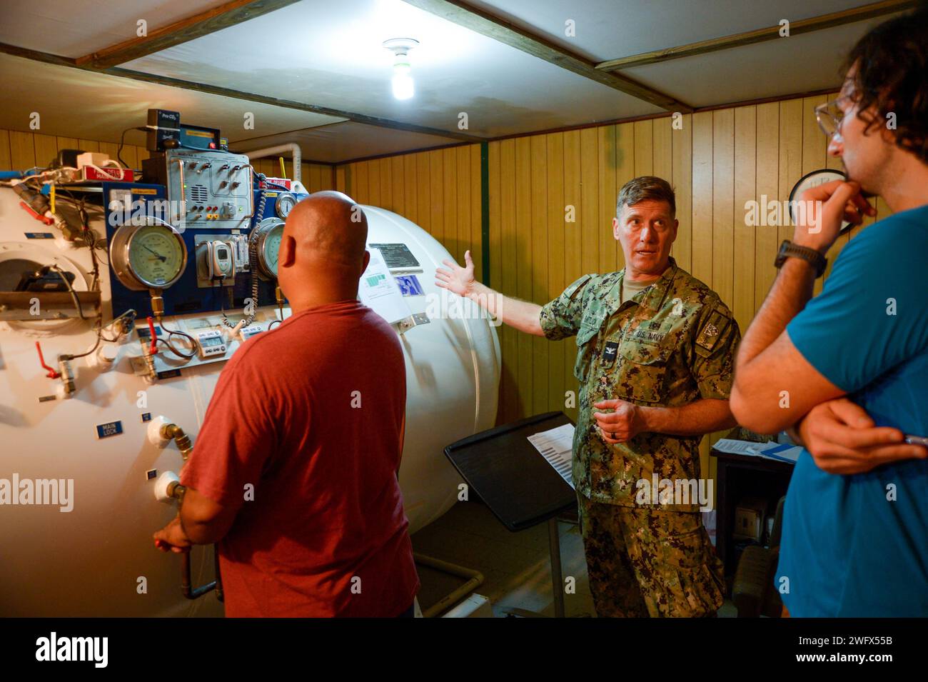 U.S. Navy Capt. Daniel Switlick, middle, explains the differences ...