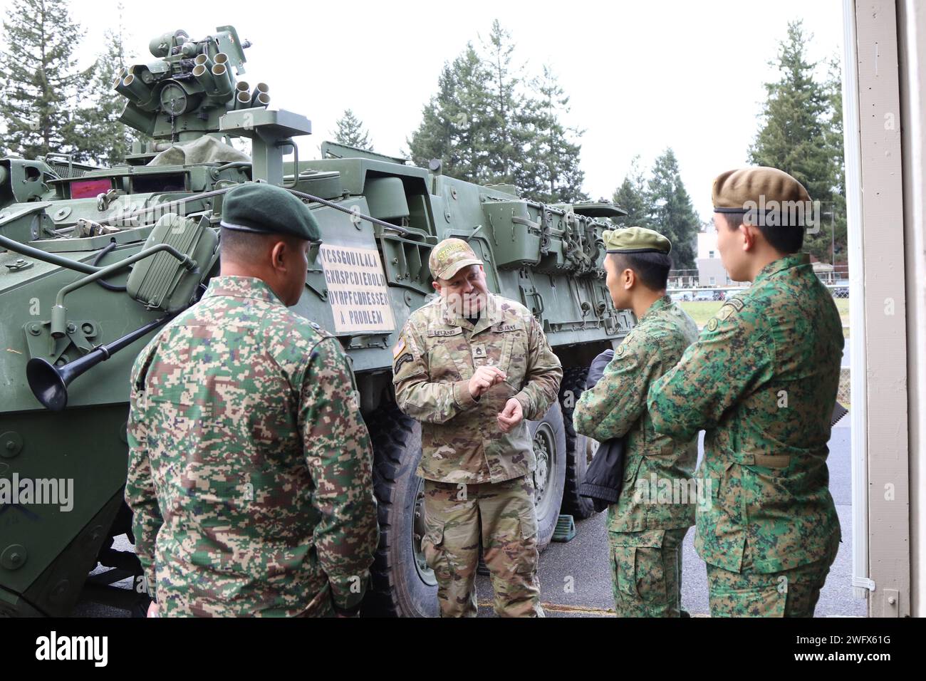A Soldier from 7th Infantry Division talks to some of our allies and ...