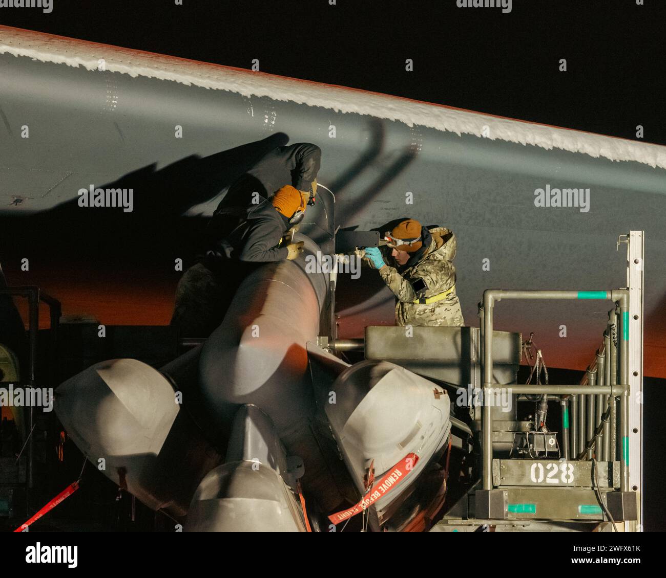 Airmen with the 5th Maintenance Group load AGM-86 air-launched cruise ...