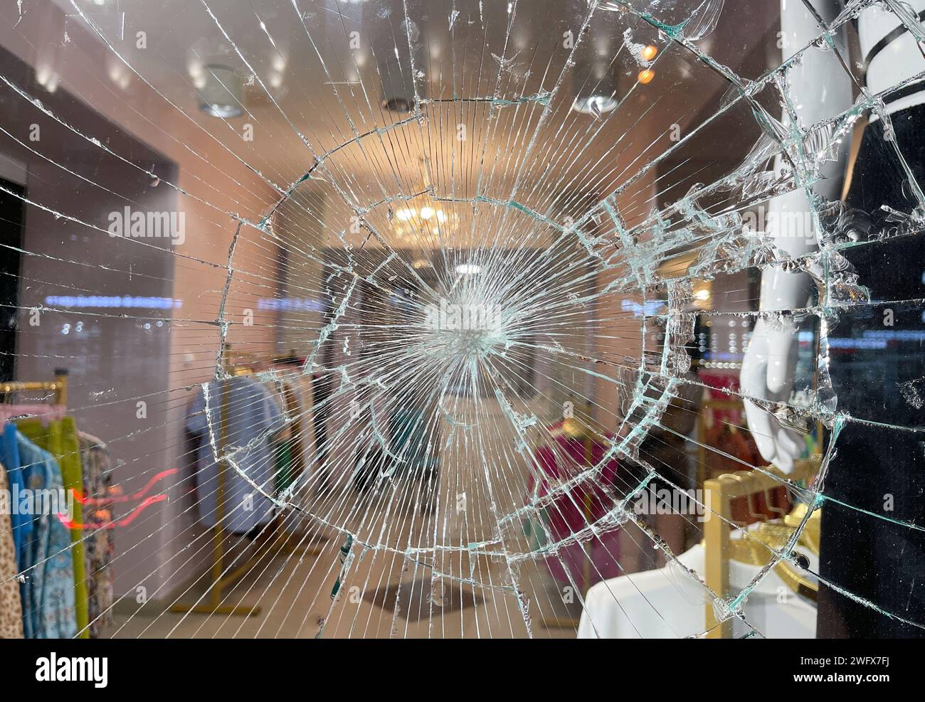 Broken window glass in a clothing store Stock Photo - Alamy