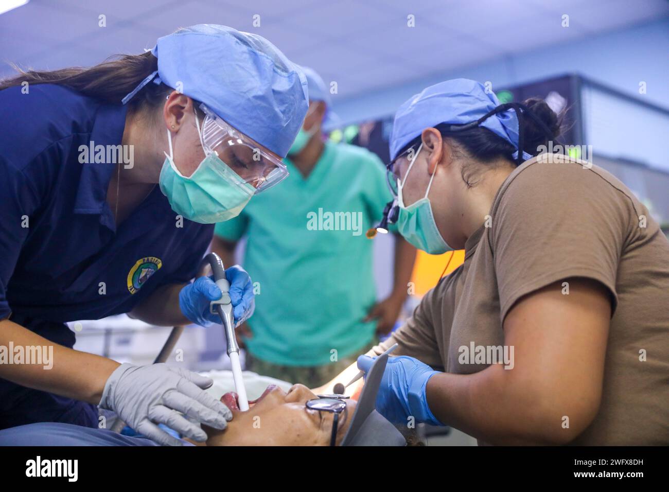 Royal Navy Able Seaman Jessica Gibbins, left, from England, removes ...